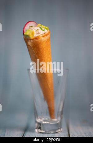 Brick cone with tuna sauce, mayonnaise, avocado and radish slice Stock ...