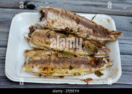 Selective focus of grilled mullet fishes with wheat gran, cleaned and ...