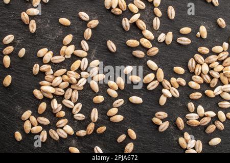 Organic pearl barley on slate stone, close-up, top view Stock Photo - Alamy