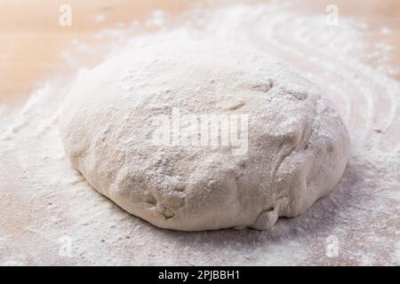 Homemade yeast dough freshly prepared for pizza or bread on wooden ...
