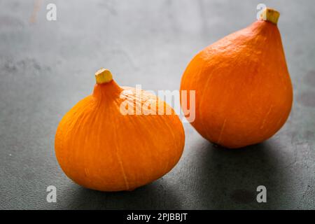 Decorative and edible pumpkins on a green background, top view, autumn ...