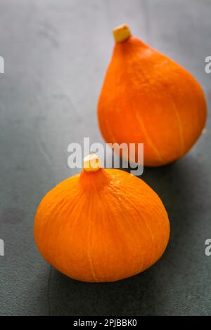 Decorative and edible pumpkins on a green background, top view, autumn ...