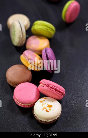 Assorted colorful macaroons on a dark background Stock Photo - Alamy