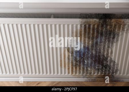 Modern panel radiator affected by rust indoors Stock Photo - Alamy