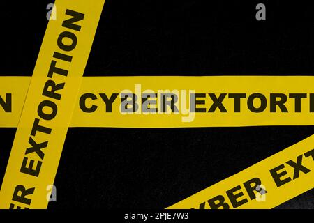 Cyber extortion caution and warning concept. Yellow barricade tape with ...