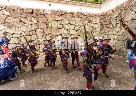 Tatsuno springtime samurai parade marching along a small road under ...