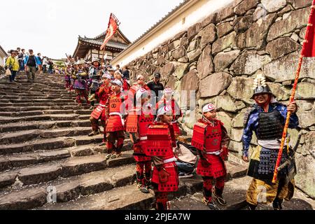 Tatsuno springtime samurai parade marching along a small road under ...