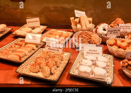 Toledo, Spain- October 6, 2022: Candied almonds, pastries, sweets and ...