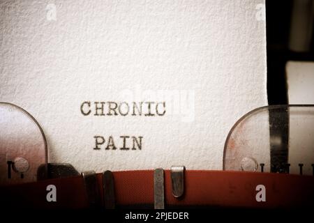 Chronic pain text written with a typewriter Stock Photo - Alamy