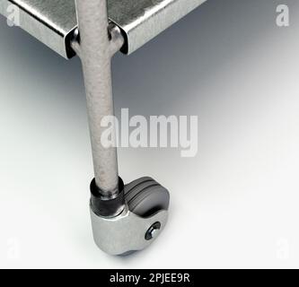 A simple stainless steel and chrome hospital or mortuary gurney with ...