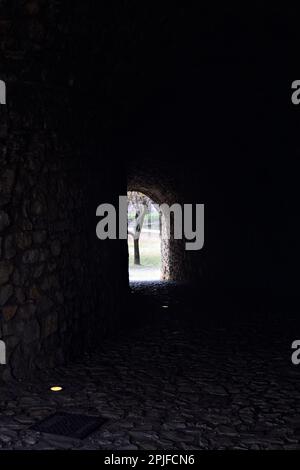 Dark and covered passage in the boundary wall of a castle Stock Photo ...