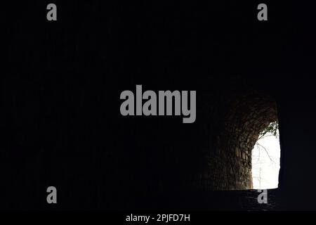 Dark and covered passage in the boundary wall of a castle Stock Photo ...