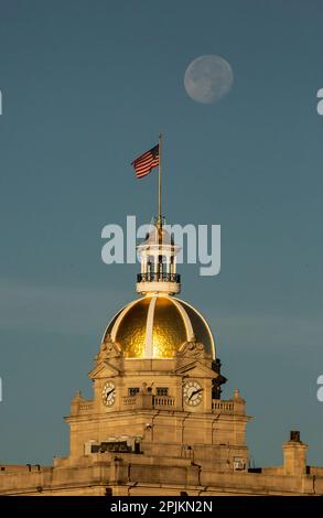 USA, Georgia, Savannah. Moon setting over City Hall along River Street ...