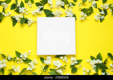 Blank canvas and beautiful jasmine flowers on yellow background, flat ...