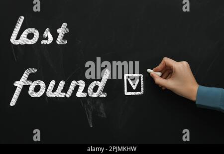 Woman write words Lost and Found on green blackboard, closeup Stock ...