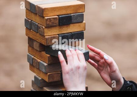 Jenga tower game in nature. Close-up shot of Jenga wooden block game ...
