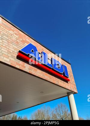 Logo lettering Aldi in blue with red underline on wall of supermarket ...