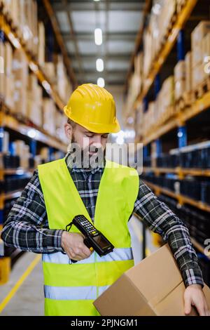 Warehouse worker stocking goods in a warehouse Stock Photo - Alamy
