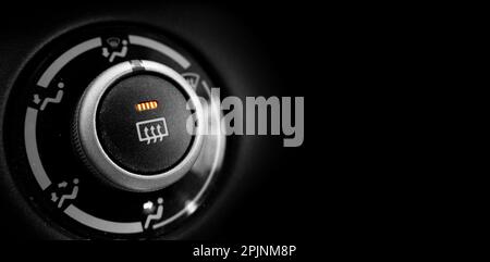Defrost button in a car turned on with orange light glowing Stock Photo ...
