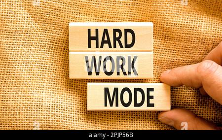 Hard work mode symbol. Concept words Hard work mode on wooden block on ...