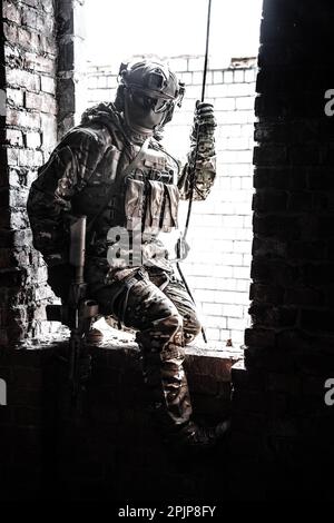 Black and white image of rappeller - police officer or soldier in ...