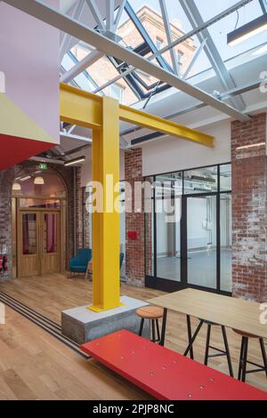 Spacious dining area with a communal table and comfortable seating in a ...