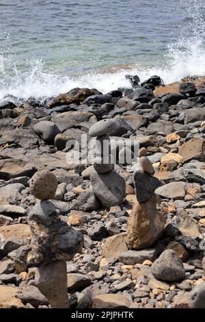 Stack of stones balancing on top of each other in the desert creating a ...