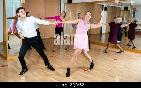 Young couple enjoying practicing jitterbug movements in studio Stock ...