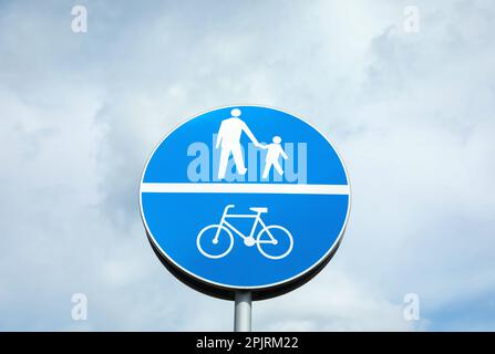 Traffic sign Compulsory Track For Pedestrians and Bicycles against blue ...
