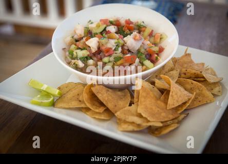 Conch Ceviche served with Tortilla chips Stock Photo - Alamy