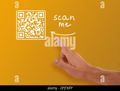 Man pointing at illustration of QR code on orange background, closeup ...