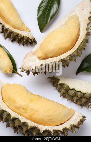 Pieces of fresh ripe durian and leaves on white background Stock Photo ...