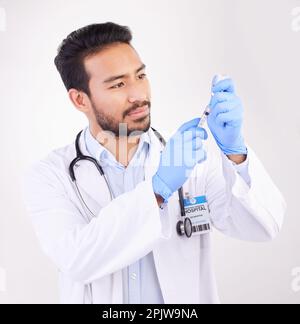 Studio shot of man doctor against brown background Stock Photo - Alamy
