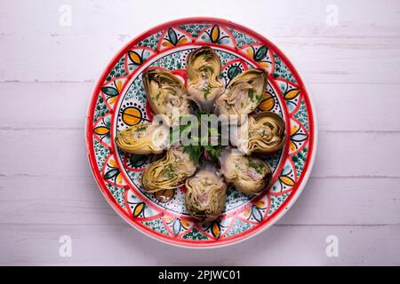 Baked artichokes with salt. Traditional Spanish recipe Stock Photo - Alamy