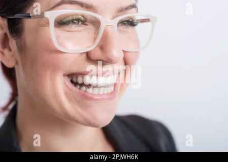 A woman uses transparent retainers to whiten teeth Stock Photo - Alamy