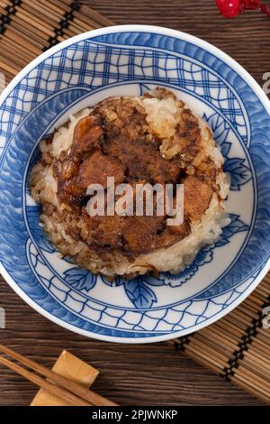 Migao, tube rice cake, rice pudding in a bowl topped with minced pork ...