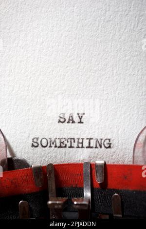 Say something text written with a typewriter Stock Photo - Alamy