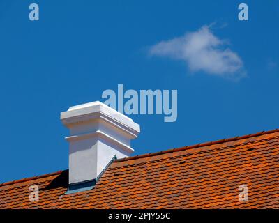 white stucco finished chimney. sloped roof with red brown clay roof ...