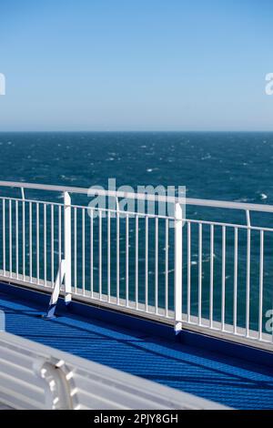 Safety railings on the deck of a ferry boat with the sea in the ...