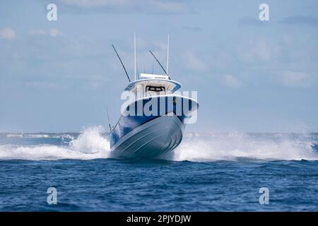 A center console fishing boat approaching head-on at high speed Stock ...