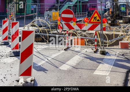 Street repair works site dewatering system with water pump, pipes and ...