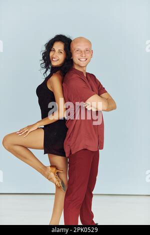Cheerful Black couple standing together clinking wine glasses and ...