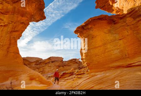 Hiker inside a stone arch in the Nevada desert near Las Vegas, Nevada ...