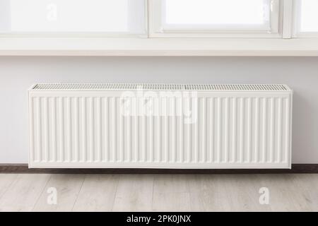 Modern radiator in room. Central heating system Stock Photo - Alamy