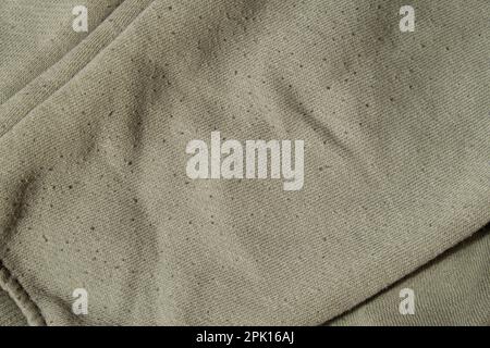 Lints on green sweater. Before cleaning and collected fluff lint ...