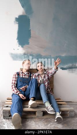 Young family planning home DIY renovation with drawing Stock Photo - Alamy