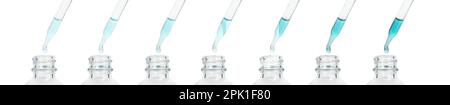 Dripping essential oils from pipettes into glass bottle on white ...