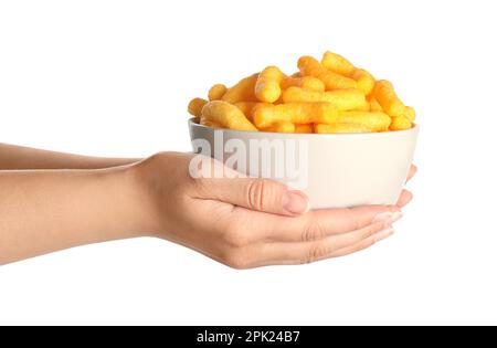 Woman holding bowl of crunchy cheesy corn sticks on white background ...