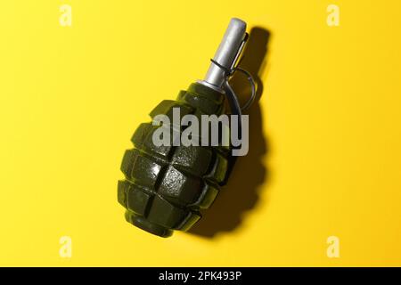 Hand grenade on yellow background, top view Stock Photo - Alamy