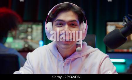 Game streamer using pc setup playing multiplayer first person shooter ...